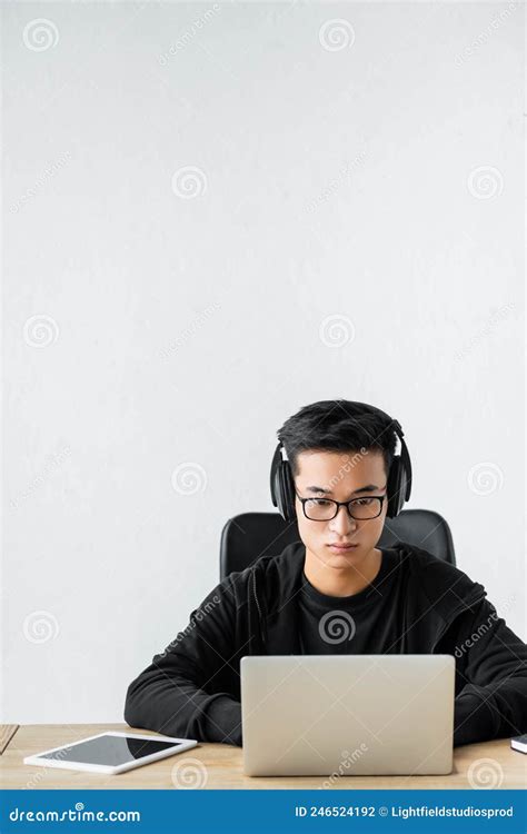 Asian Hacker In Headphones Using Laptop Stock Photo Image Of Inside Profession 246524192