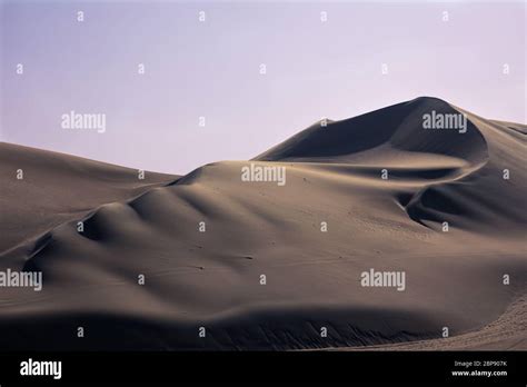 Sunset In The Desert Dunes In The Oasis Of Huacachina Peru One Stock