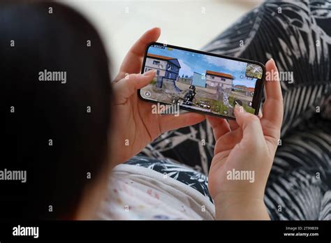 Pubg Playerunknowns Battlegrounds Mobile Ios Game On Iphone 15 Smartphone Screen In Female Hands