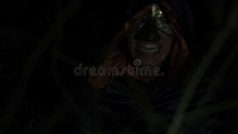 Portrait Of Alight Vampire Face Scaring In Grass At Night Stock Video