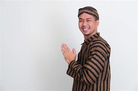 Premium Photo Side View Of Javanese Man Smiling At Camera While Doing