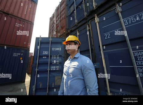 Engineer Or Supervisor Checking And Control Loading Containers Box From Cargo At Harbor Foreman