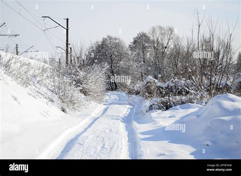 The Road That Lies Parallel To The Railway Line Is Covered With Snow On