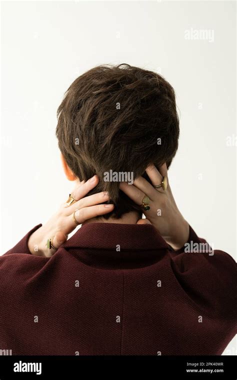 Back View Of Brunette Short Haired Woman In Finger Rings Posing With