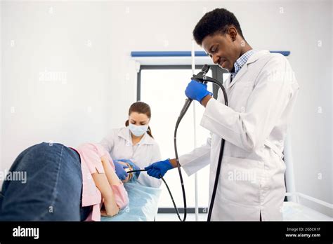 Young African American Man Doctor And Female Nurse Doing Endoscopy
