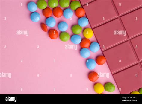 Ruby Chocolate Bar With Colorful Chocolate Candy Tablets On Pink