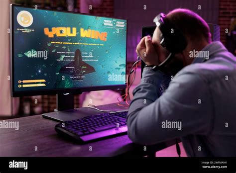 Gamer Playing Intense Classic Arcade Spaceship Racing Videogame Wiping Happiness Tears From