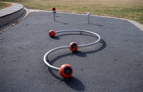 Unique Playground Structure With Metal Curves And Colored Spheres On Rubber Surface Stock Image