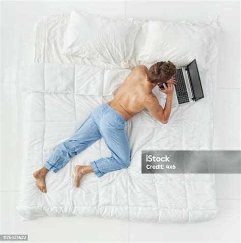 전체 길이한 사람한 사람직접 위의 보기후면뒤 2029 세 성인 잘 생긴 사람 갈색 머리짧은 머리 백인 남성젊은 남자 침실에서 잠