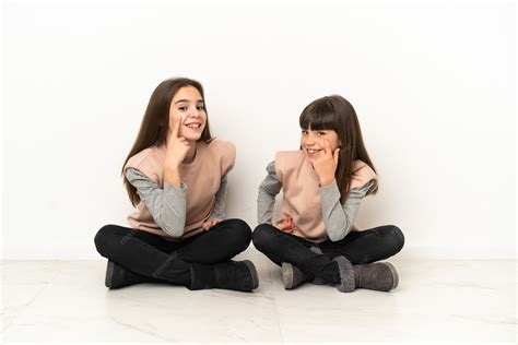 Premium Photo Little Sisters Sitting On The Floor Isolated On White