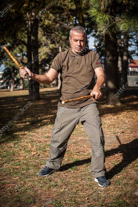 Escrima And Kapap Instructor Demonstrates Sticks Fighting Techniques In