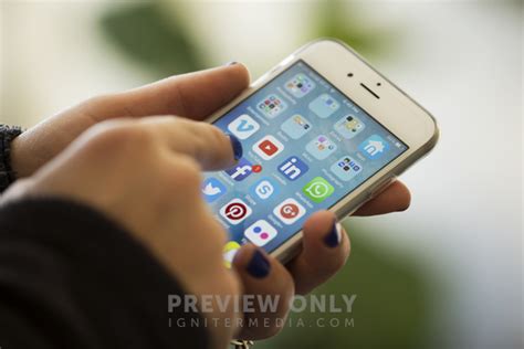Woman Checking A Social Media Notification On Her Cell Phone Stock