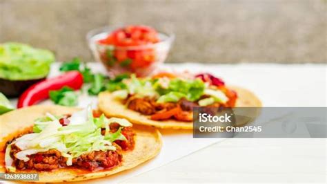 뽑은 돼지고기 쇠고기 칠리 콘 카른을 곁들인 멕시코 전통 정통 수제 타코와 토마토 샐러드 아보카도 과카몰리 딥 소스제공 0명에 대한 스톡 사진 및 기타 이미지 Istock