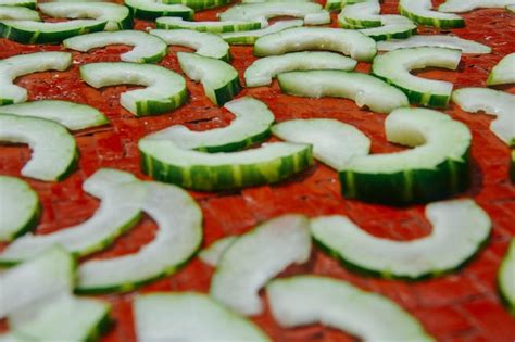 Premium Photo Chopped Cucumber Slices On Red Table