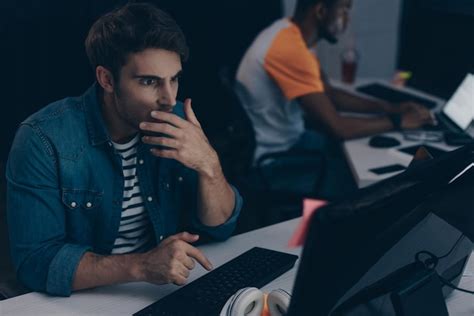 Premium Photo Selective Focus Of Shocked Programmer Working At Night