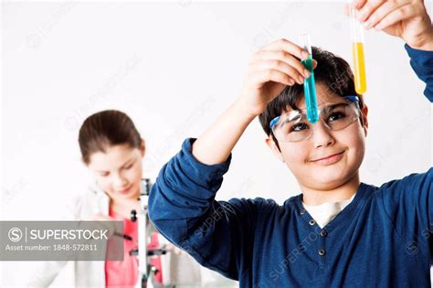 Babe And Girl During A Chemistry Class SuperStock