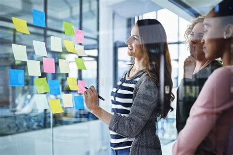 Generating Some Fresh And Innovative Ideas A Team Of Designers Brainstorming With Notes On A