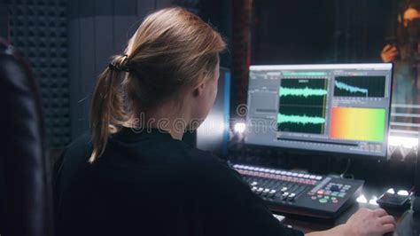 Female Sound Engineer Uses Control Mixing Surface And Computer Stock