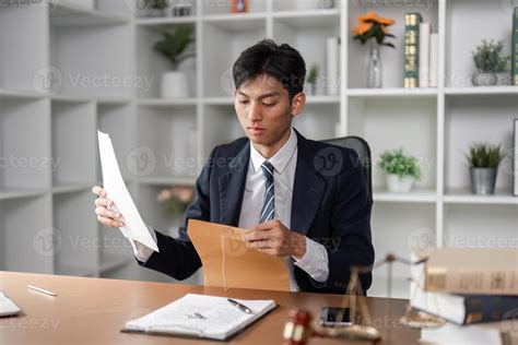 Young Businessman Analyzing Documents And Preparing For Important Tasks In A Modern Office