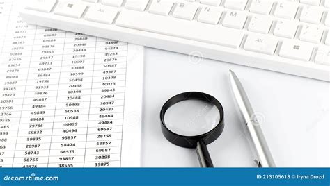 business work with chart magnifier pen and keyboard on white office desk top view stock image