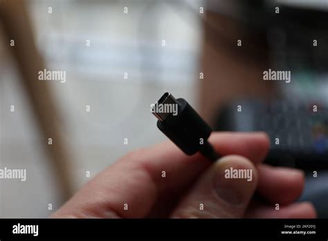 A Portrait Of Someone Holding A Usb C Cable In His Hands Ready To