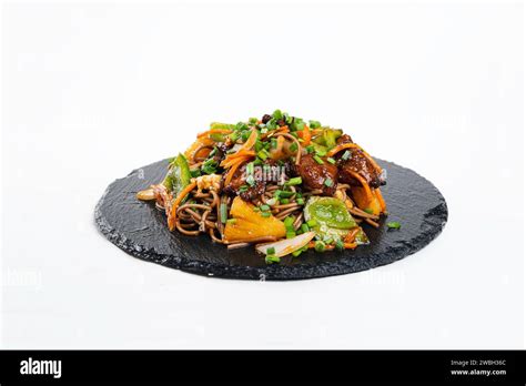 Fried Assorted Vegetables With Meat In A Flat Plate On A White