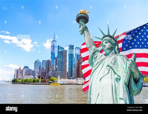 Statue Of Liberty With Large American Flag In The Background Stock