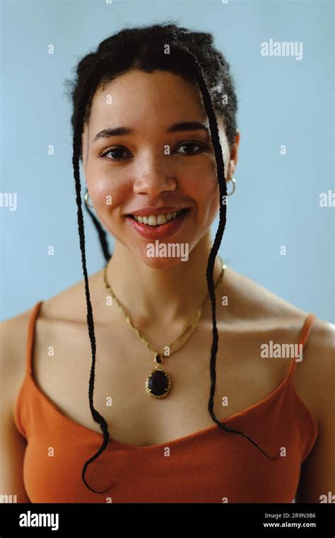 Smiling Young Adult Woman With Braids She Wears Orange Tank Top In