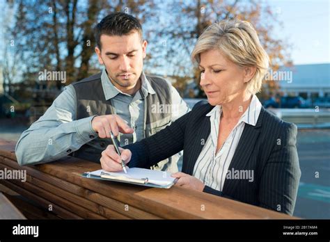 Female And Male Employee Writing Notes Outdoors Stock Photo Alamy