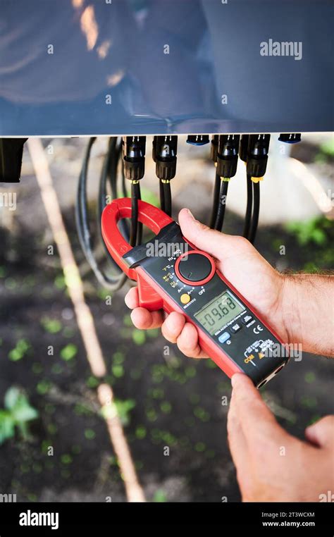 Checking Of Output Voltage Level Of Inverter Professional Worker Using Current Clamps To