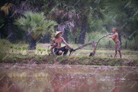 Premium Photo Shirtless Father And Son Farming At Farm