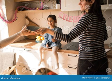 Guests Passing Plates To Each Other Before Serving Birthday Cake Stock Image Image Of