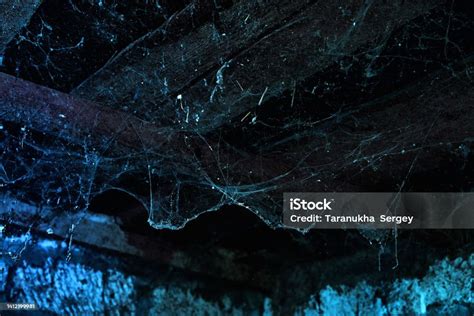 A Creepy Spider Web Hanging From The Ceiling Of An Old Abandoned House