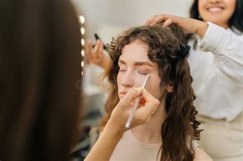 Close Up Of Unrecognizable Makeup Artist Applying Eyeshadow To Eyelids