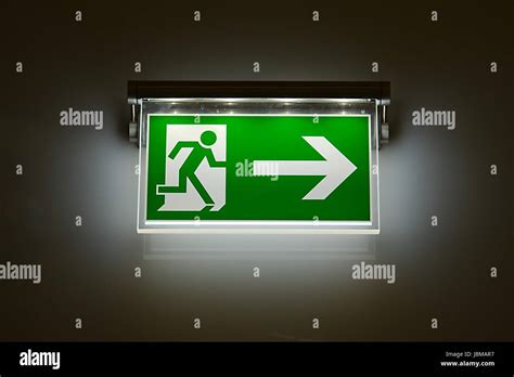 Emergency Exit Sign Glowing In The Dark Stock Photo Alamy