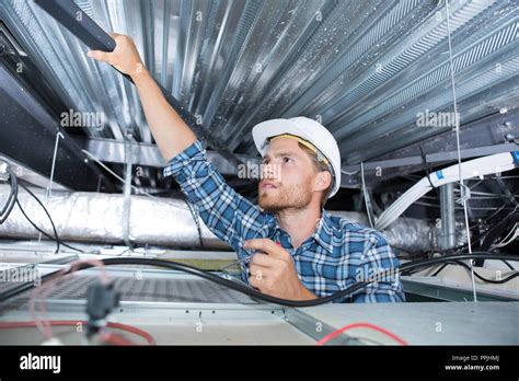 Electrician Repairing Ceiling Light Stock Photo Alamy