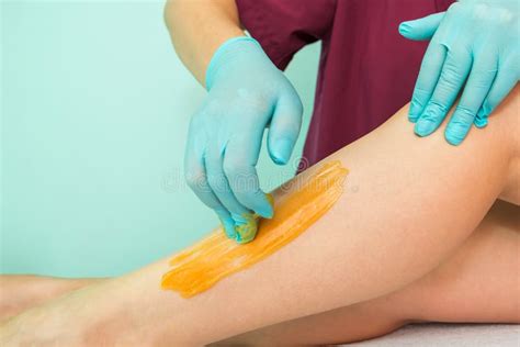 Woman Undergoing Leg Hair Removal Procedure With Sugaring Paste In