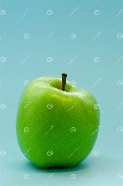 One Green Apple On A Light Blue Background With A Minimalistic