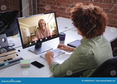 Multiracial Male And Female Colleagues Discussing Work On Video Call Through Desktop Pc In