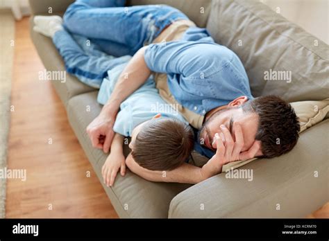 Father And Son Sleeping On Sofa At Home Stock Photo Alamy
