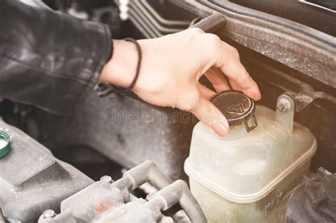 Close Up Girl Checks The Level Of Coolant In The Engine Of Her Car Stock Image Image Of Garage