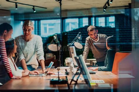 Three Young Women In A Modern Office Solve A Problem Together While