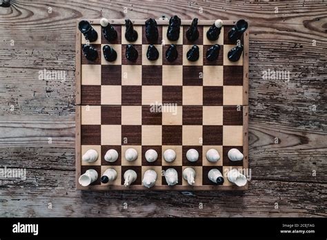 From Above View Of Chessboard With Chess Pieces On Wood Background