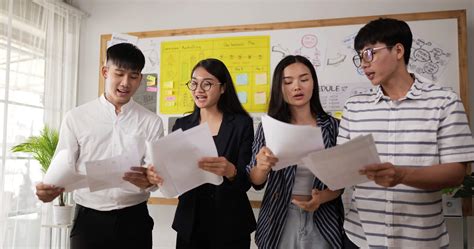 four business people having an argument while standing in an office