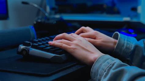 hands typing rapidly on a backlit keyboard dropshot stock royalty