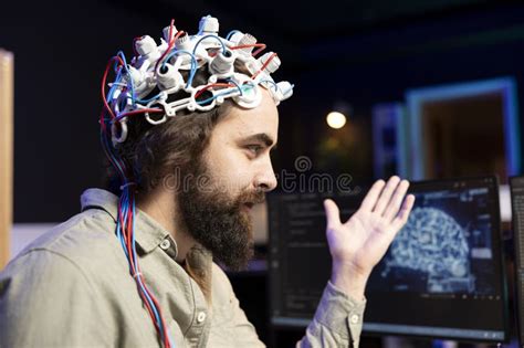 Smiling Technician Using Eeg Headset To Upload Consciousness Into