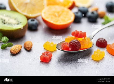 Chewable Gummy Bears Vitamins And Supplements And Fresh Fruits Stock Photo Alamy