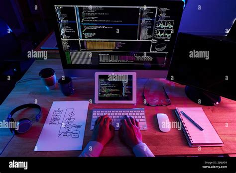 Concentrated Male Software Developer Wrapped Up In Work While Sitting In Front Of Computer At
