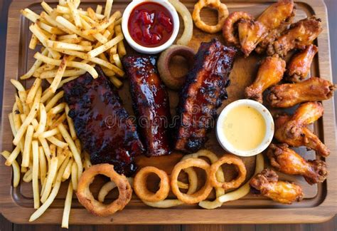 Hearty Bbq Platter With Ribs Wings And Fries Stock Illustration
