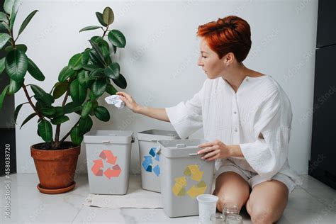 Peaceful Woman Sorting Garbage Beween Small Recycle Bins At Home Stock Photo Adobe Stock